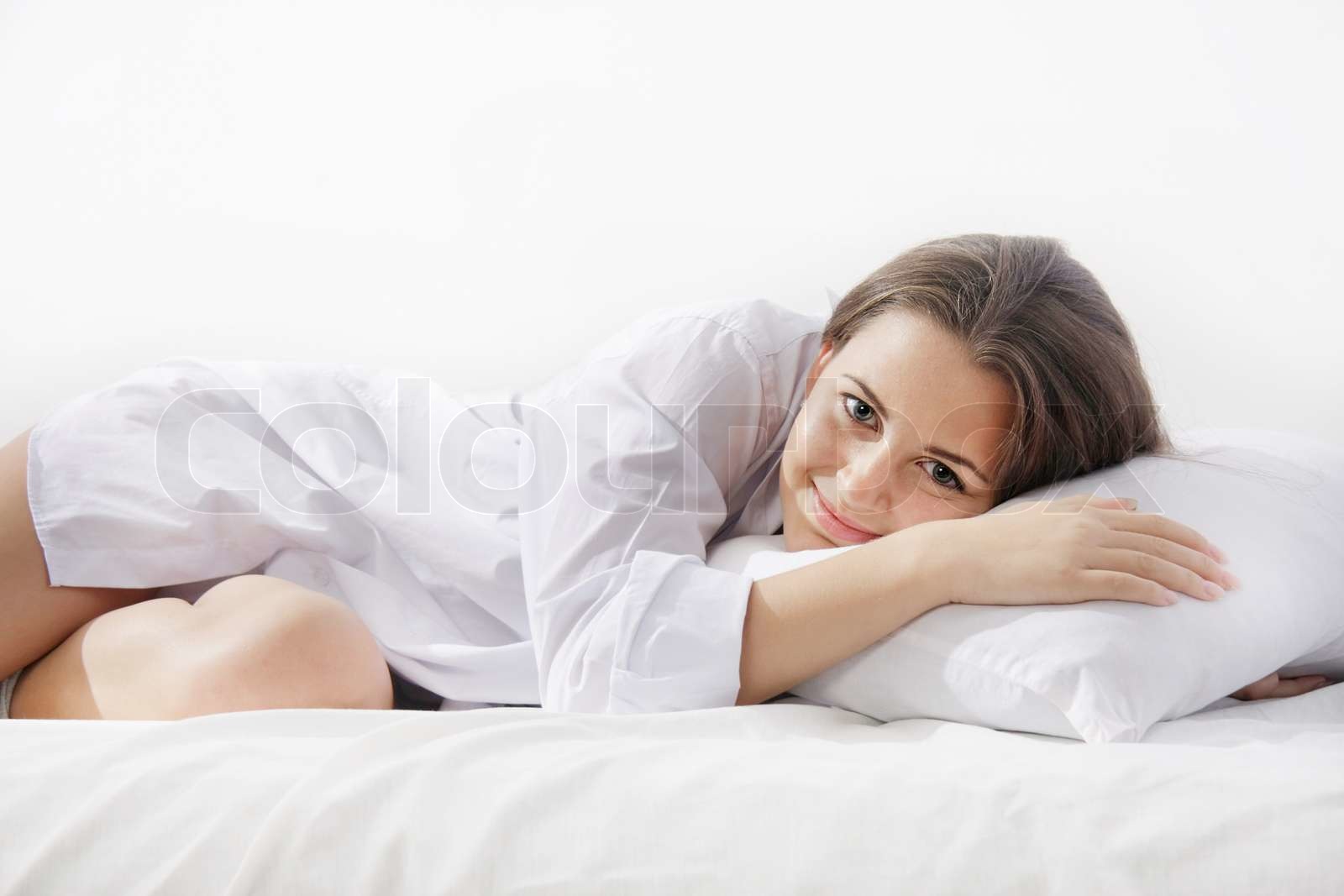 young smiling woman relaxing in bed | Stock image | Colourbox