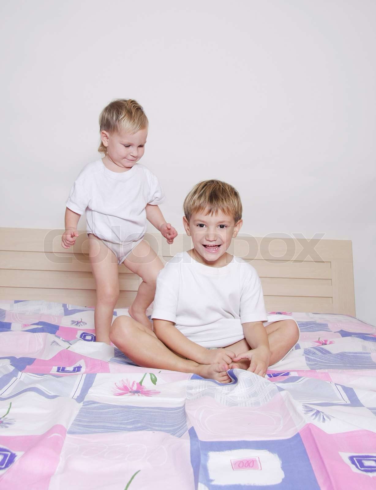 two children on parent's bed | Stock image | Colourbox