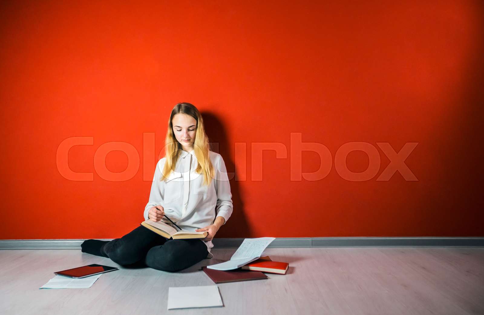Persistent Young Student Girl Studying on Floor | Stock image | Colourbox