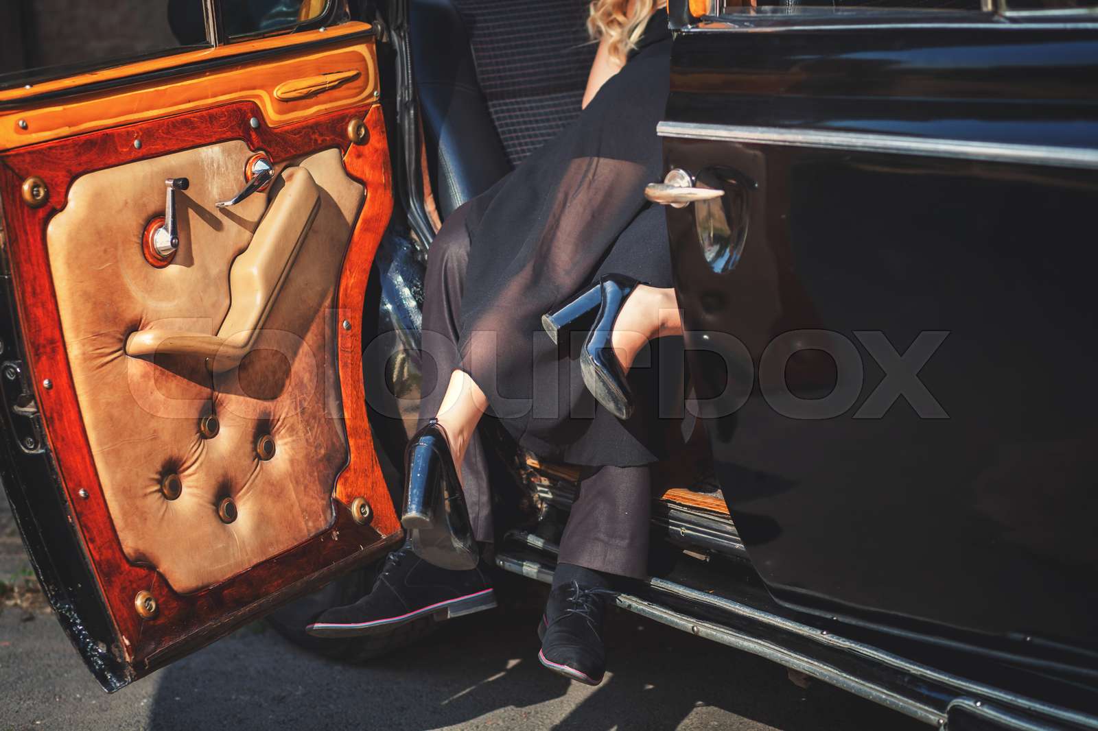 Woman`s and man`s legs in car | Stock image | Colourbox