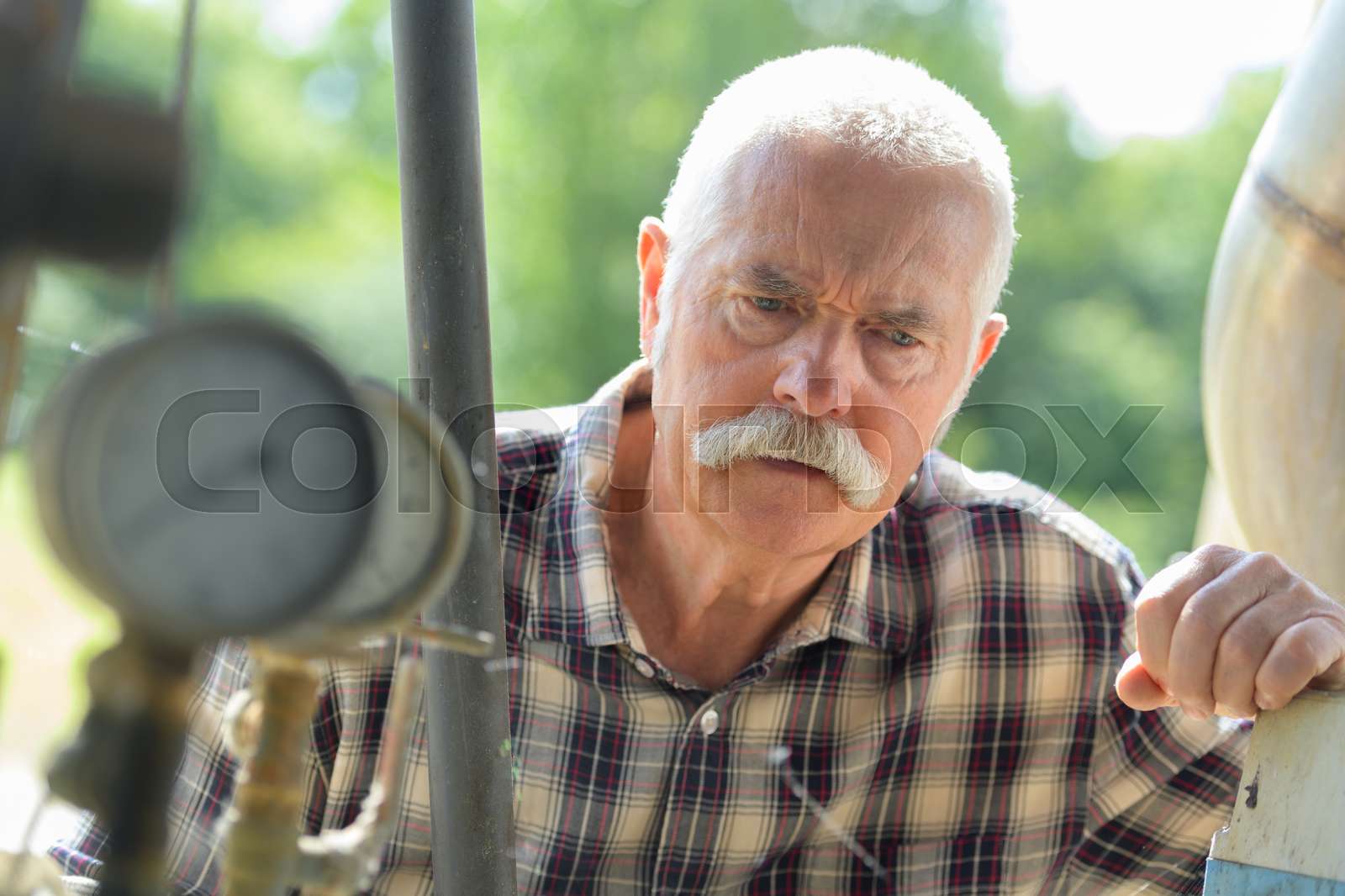 old-man outdoors checking machine | Stock image | Colourbox