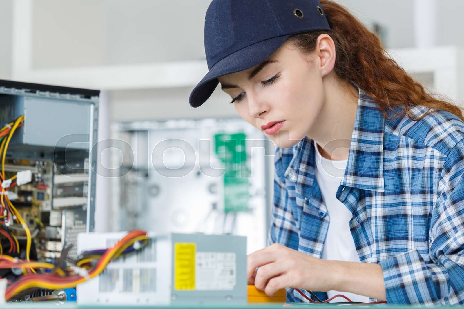 female pc technician fixing a pc | Stock image | Colourbox