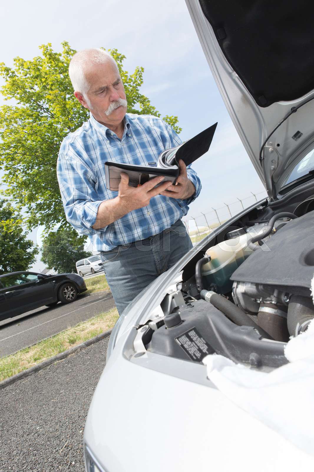 older man checking levels and servicing his car | Stock image | Colourbox