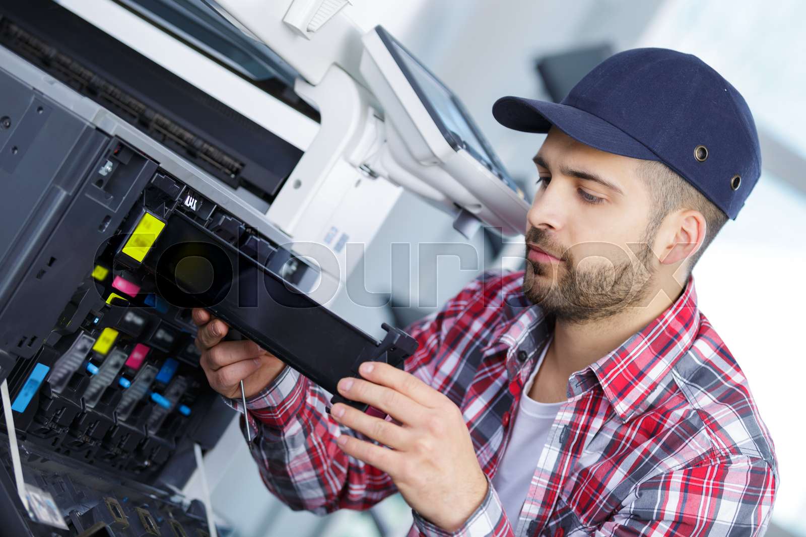 man repairing a printer at work | Stock image | Colourbox