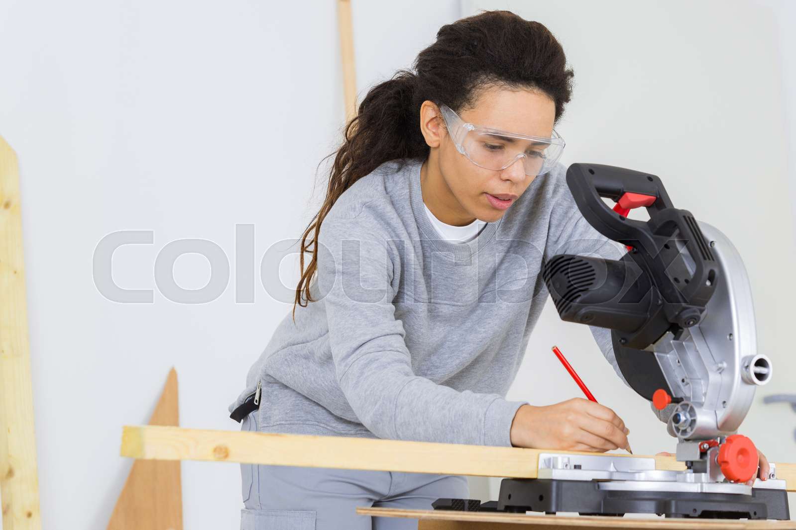 woman sanding a pieces of wood by electric sander diy | Stock image ...