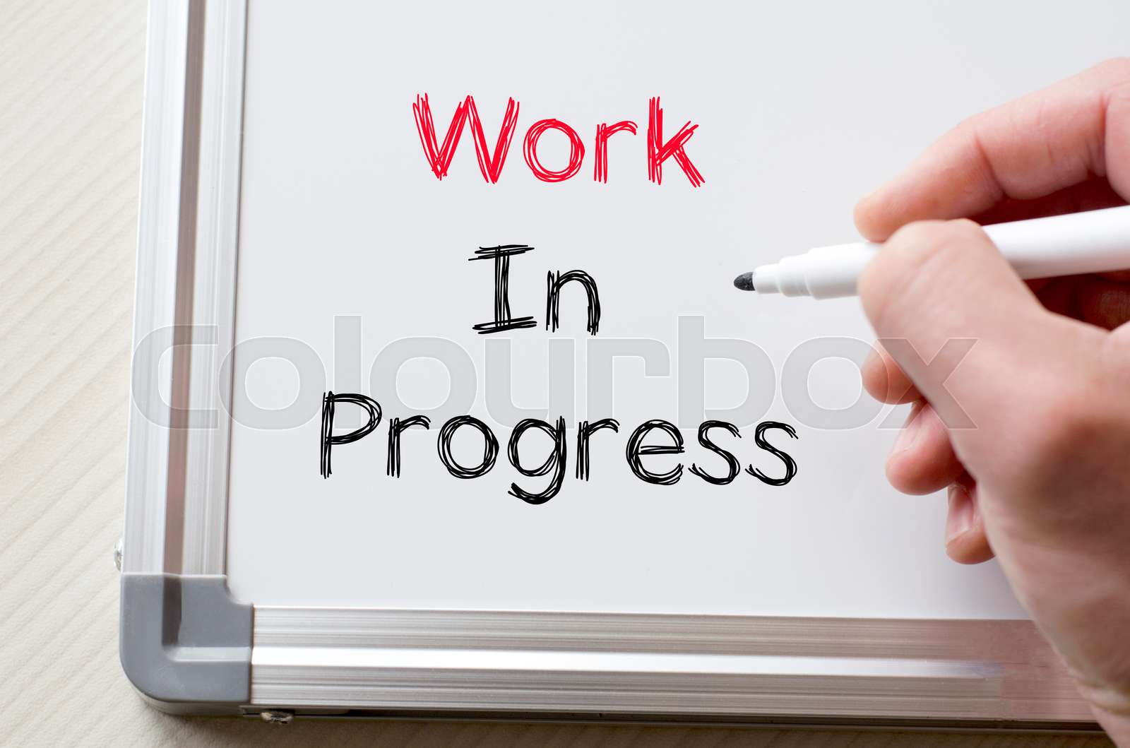 Work in progress written on whiteboard | Stock image | Colourbox