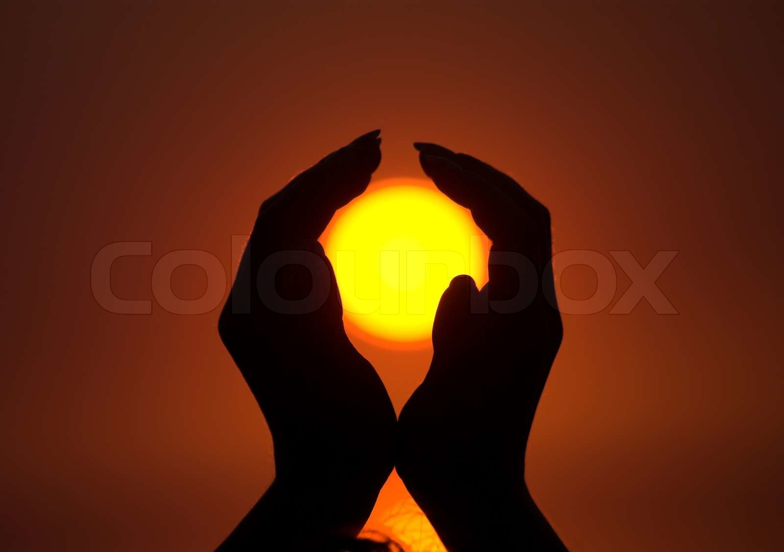 Sun in beautiful female hands during sunrise | Stock image | Colourbox