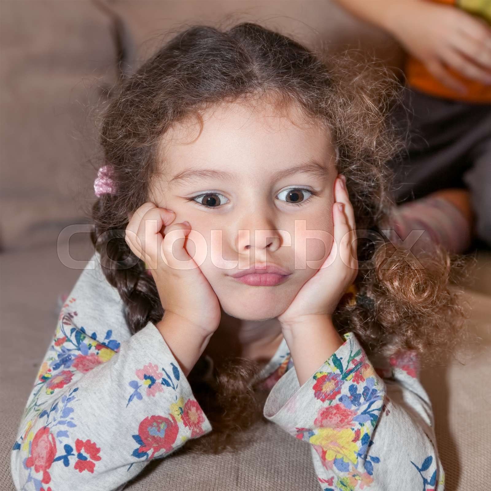 Child propped up hands head | Stock image | Colourbox