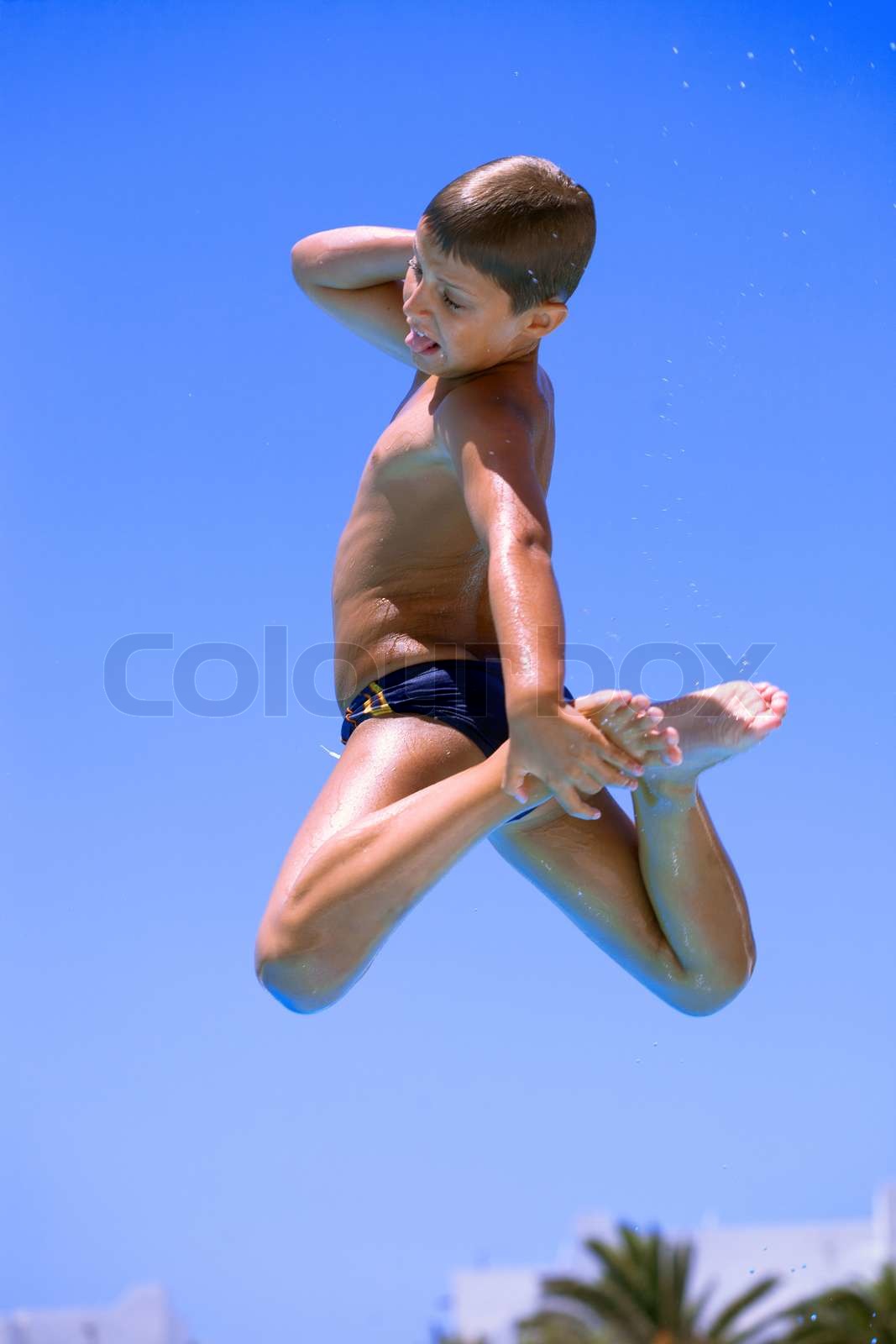 boy jumping into the pool smiling | Stock image | Colourbox