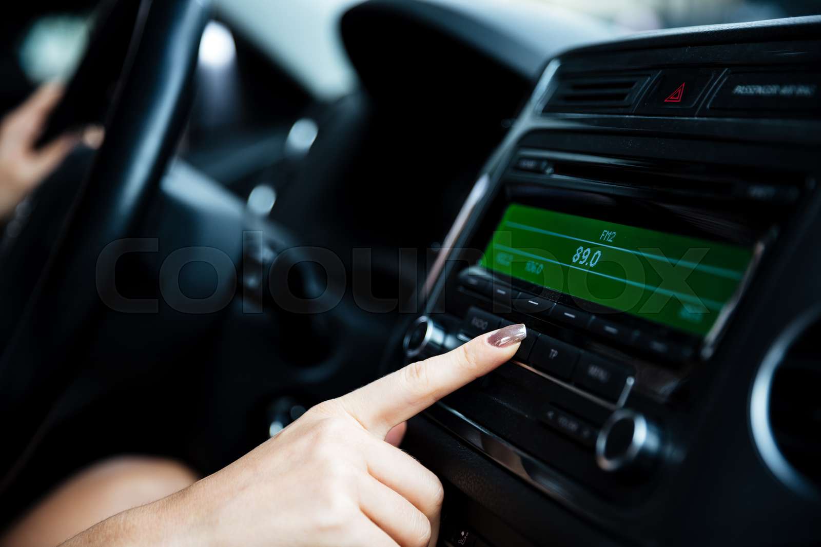 Woman hand pushing the power button in car | Stock image | Colourbox