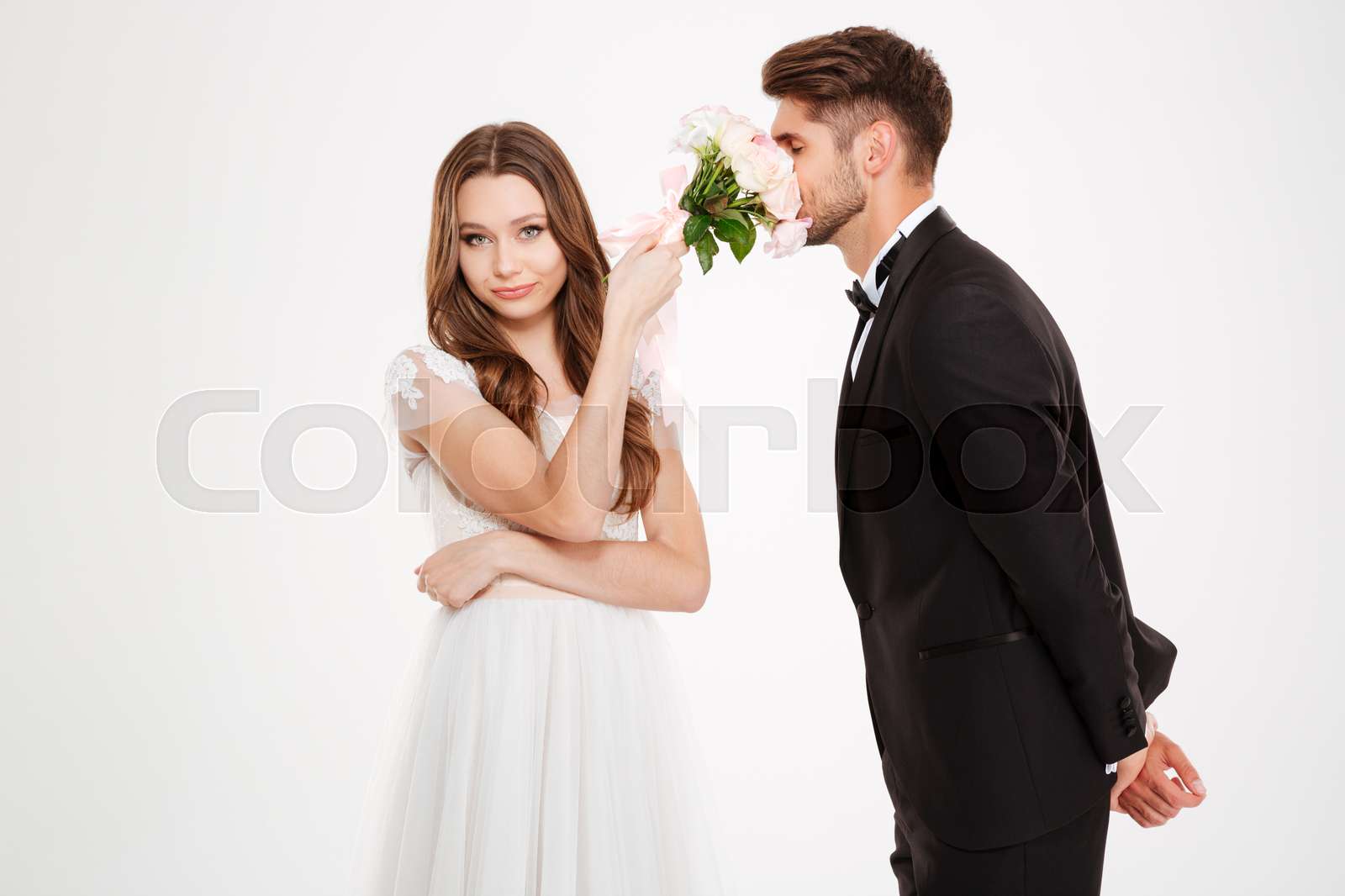 Guy sniffing flowers | Stock image | Colourbox