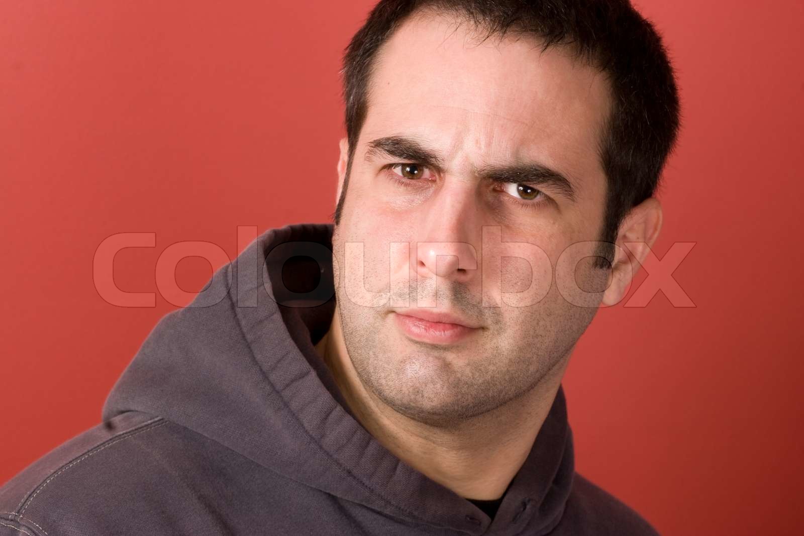 A young man with a very serious look on his face | Stock image | Colourbox