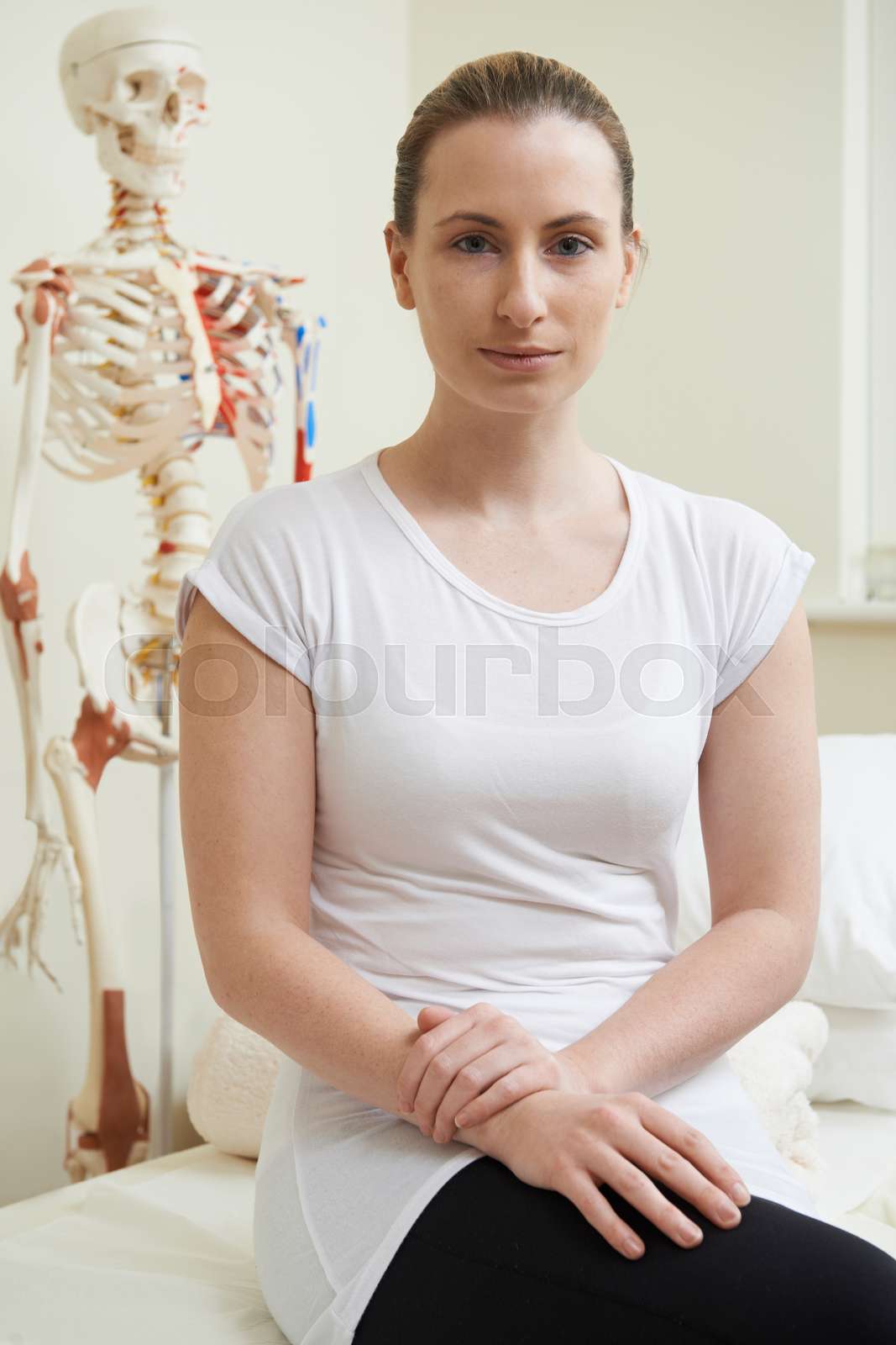 Portrait Of Female Osteopath In Consulting Room | Stock image | Colourbox