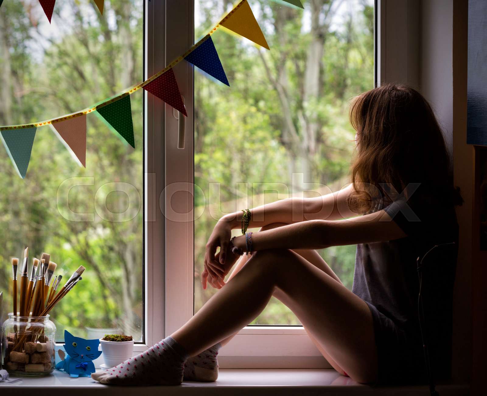 teen girl sitting on a windowsill 5 | Stock image | Colourbox
