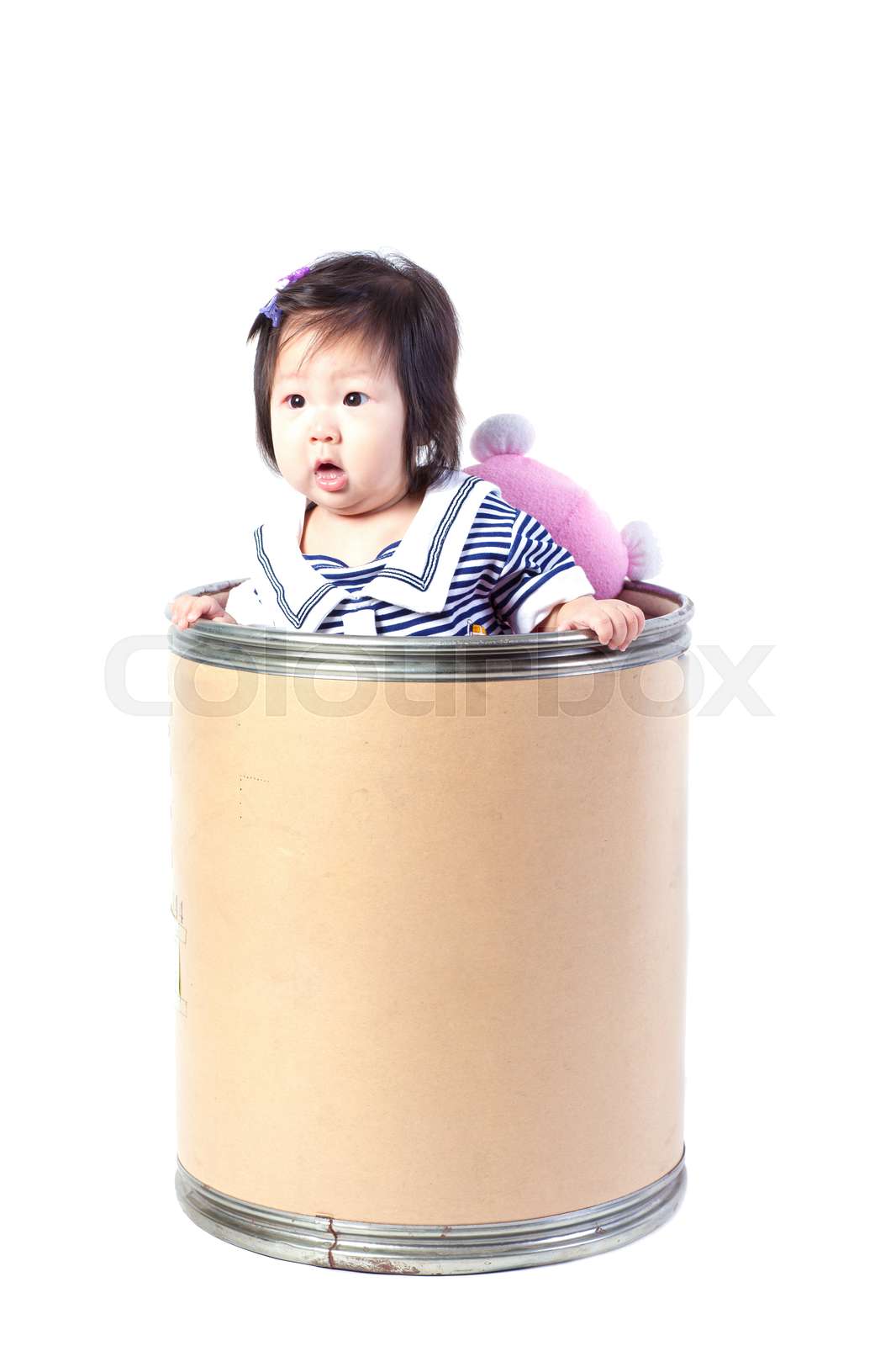 A cute girl sitting in a Chemical bucket | Stock image | Colourbox