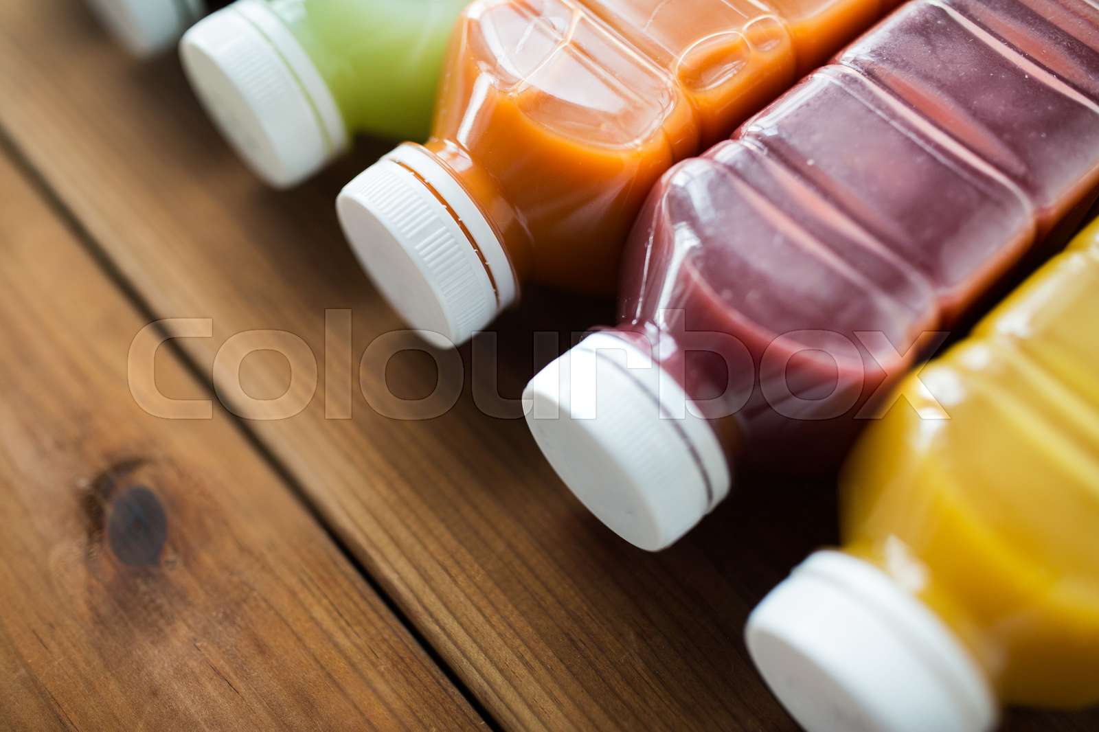 bottles with different fruit or vegetable juices | Stock image | Colourbox