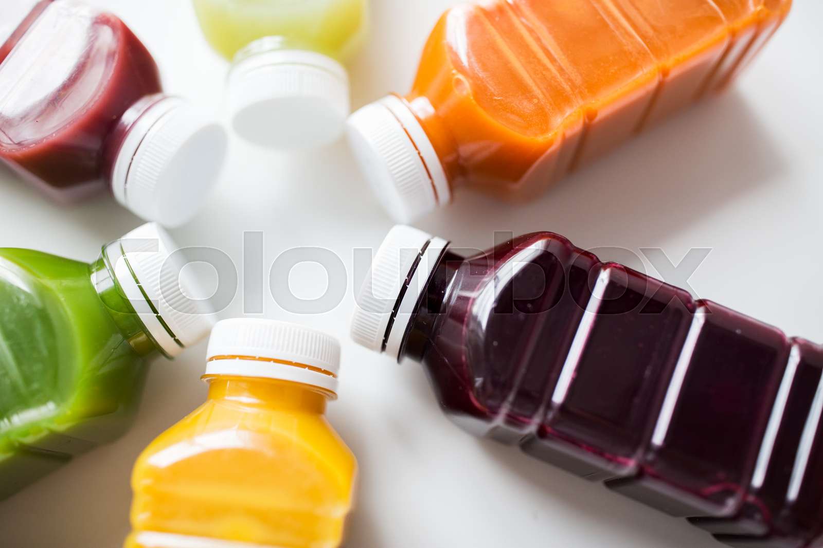 bottles with different fruit or vegetable juices | Stock image | Colourbox