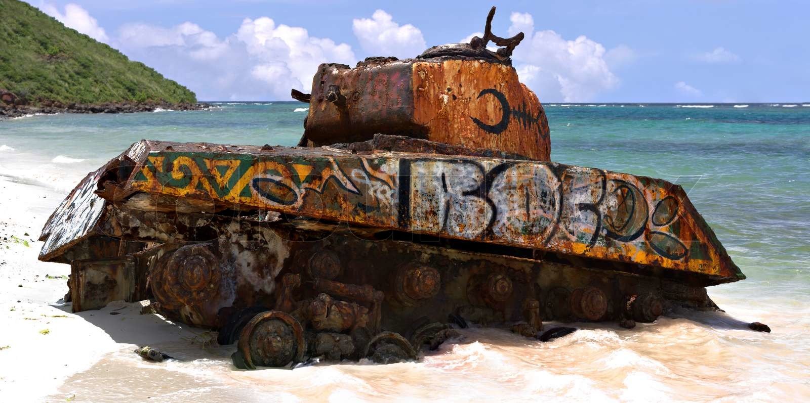 The old rusted and deserted US army tank of Flamenco beach on the ...