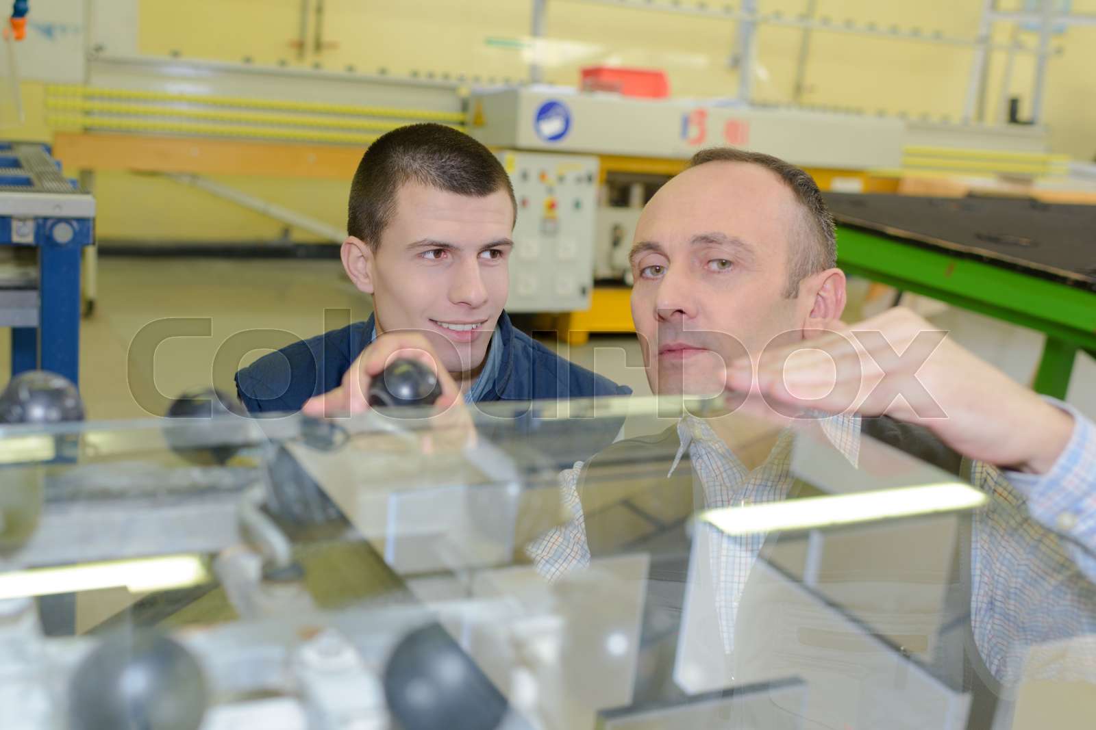 workers using press machine in paper factory | Stock image | Colourbox