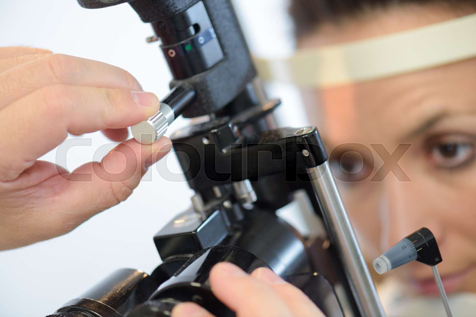 woman having eye test at eye test machine | Stock image | Colourbox