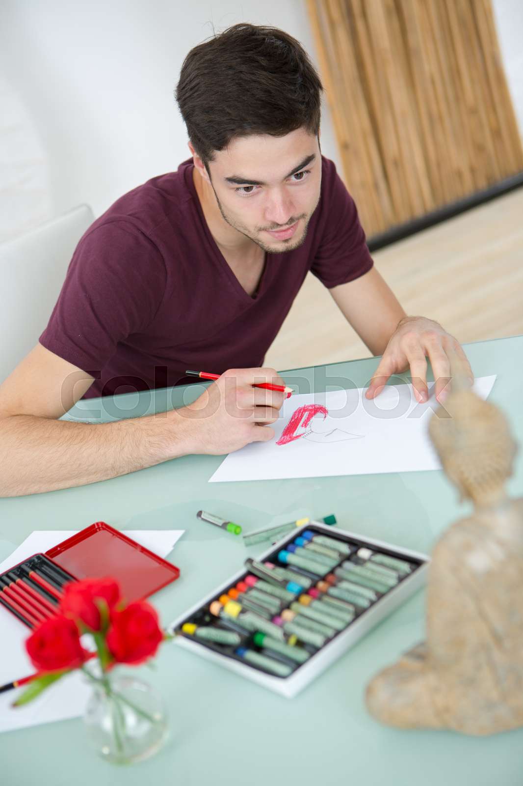 Young male artist doing still life drawing | Stock image | Colourbox