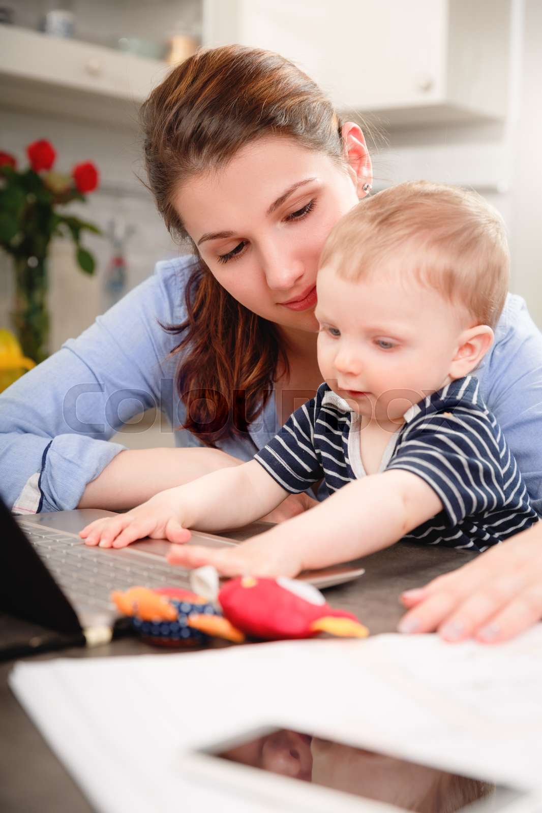 Young mother working with her baby | Stock image | Colourbox