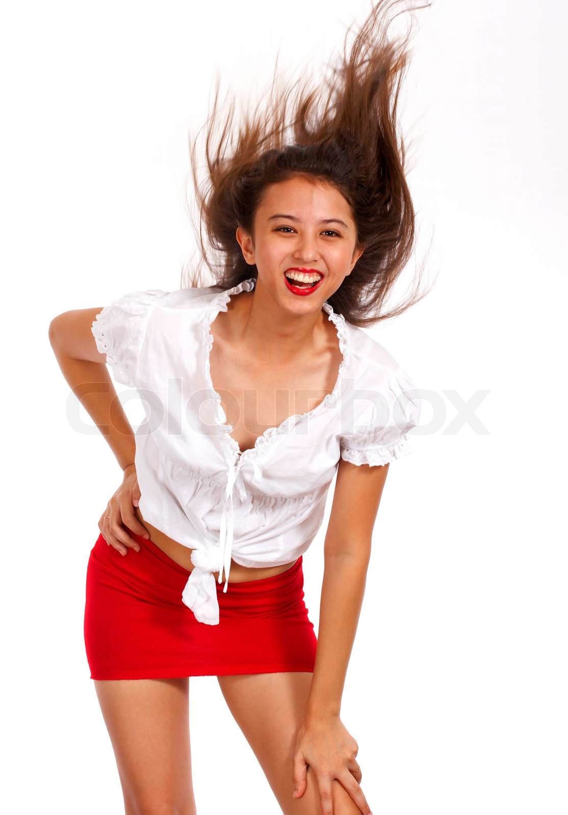 Excited Girl In Mini Skirt Throwing Back Her Hair | Stock image | Colourbox