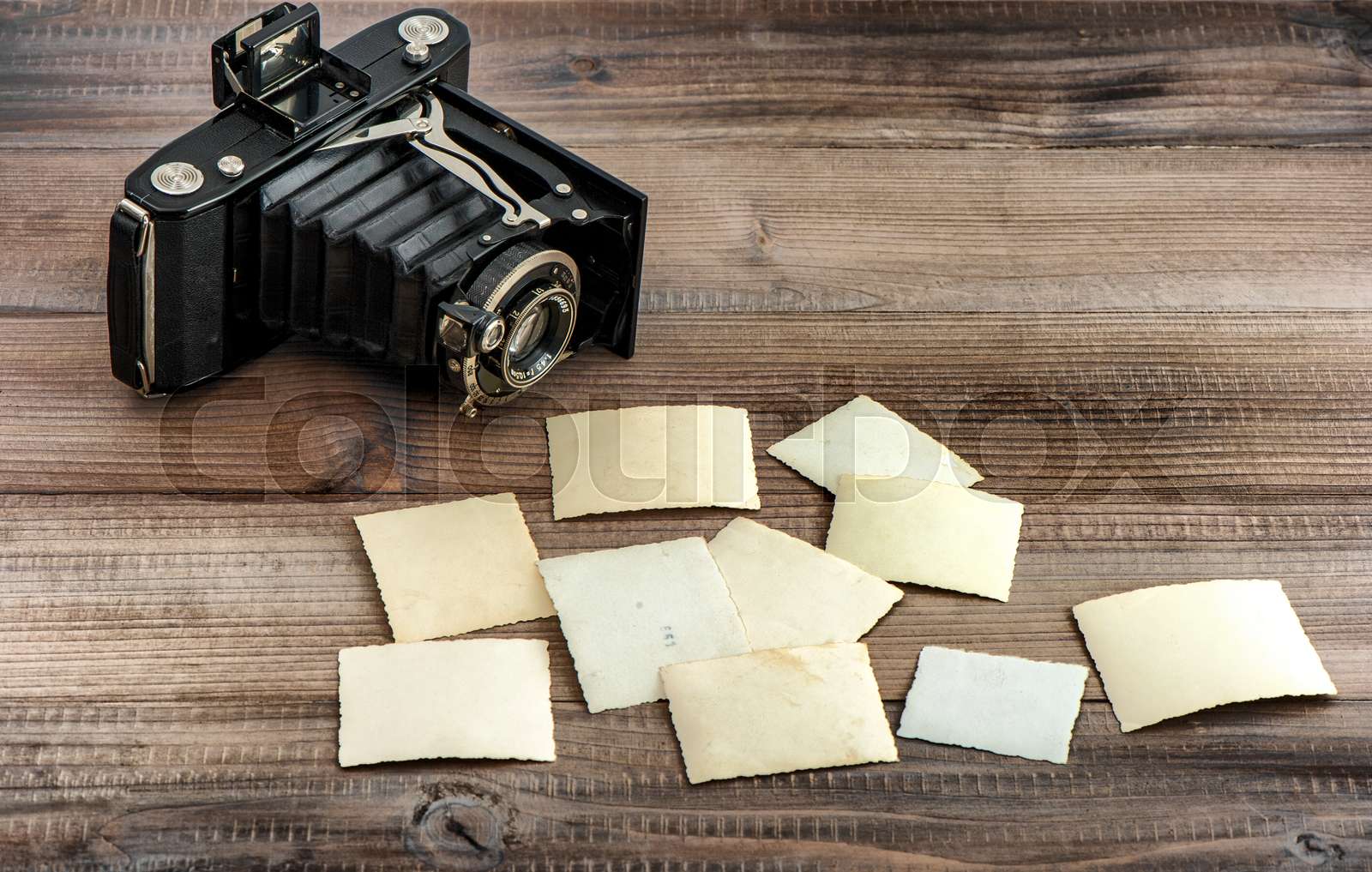 Vintage photo camera and old paper photos | Stock image | Colourbox