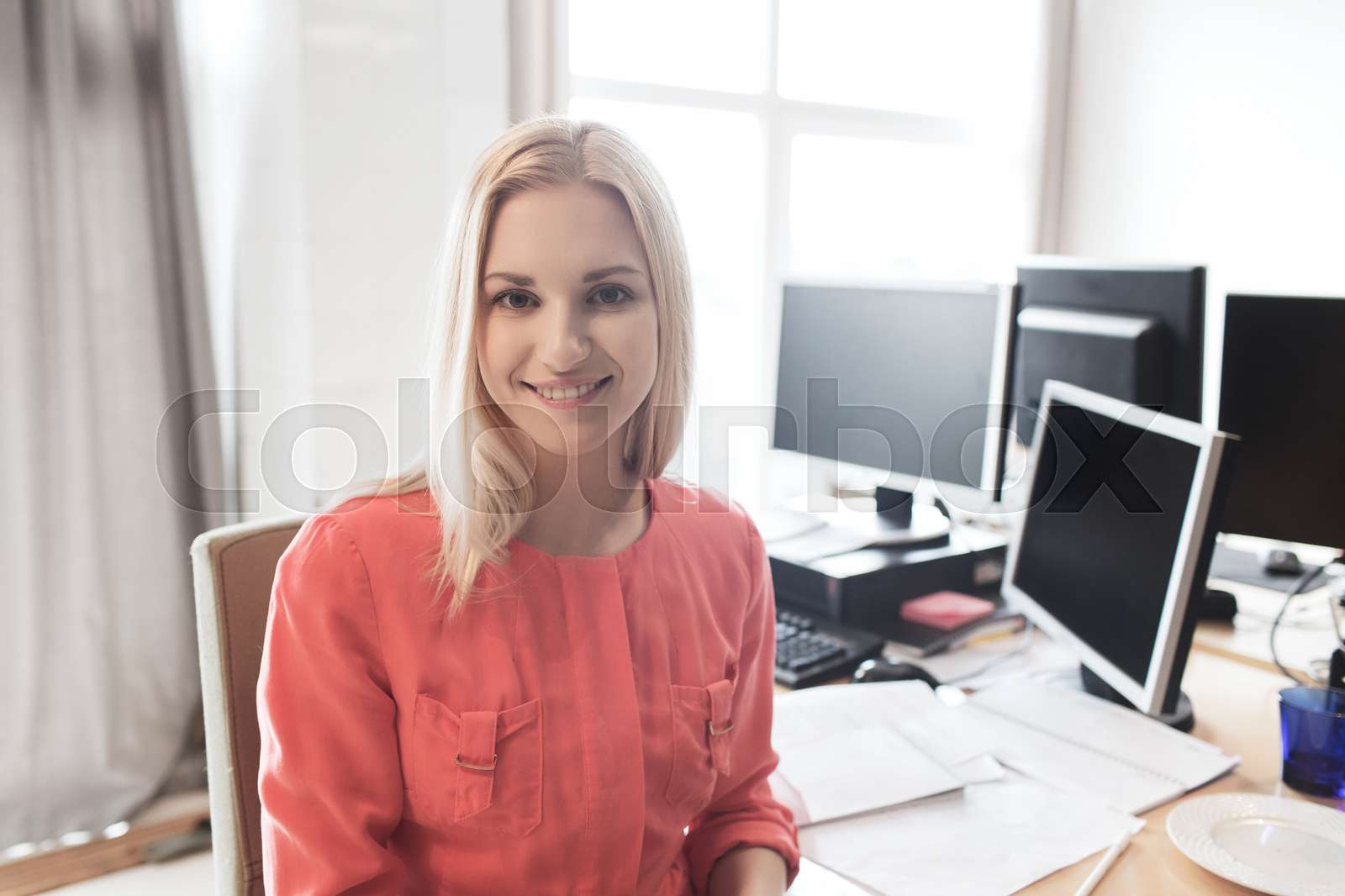 happy creative female office worker with computers | Stock image ...