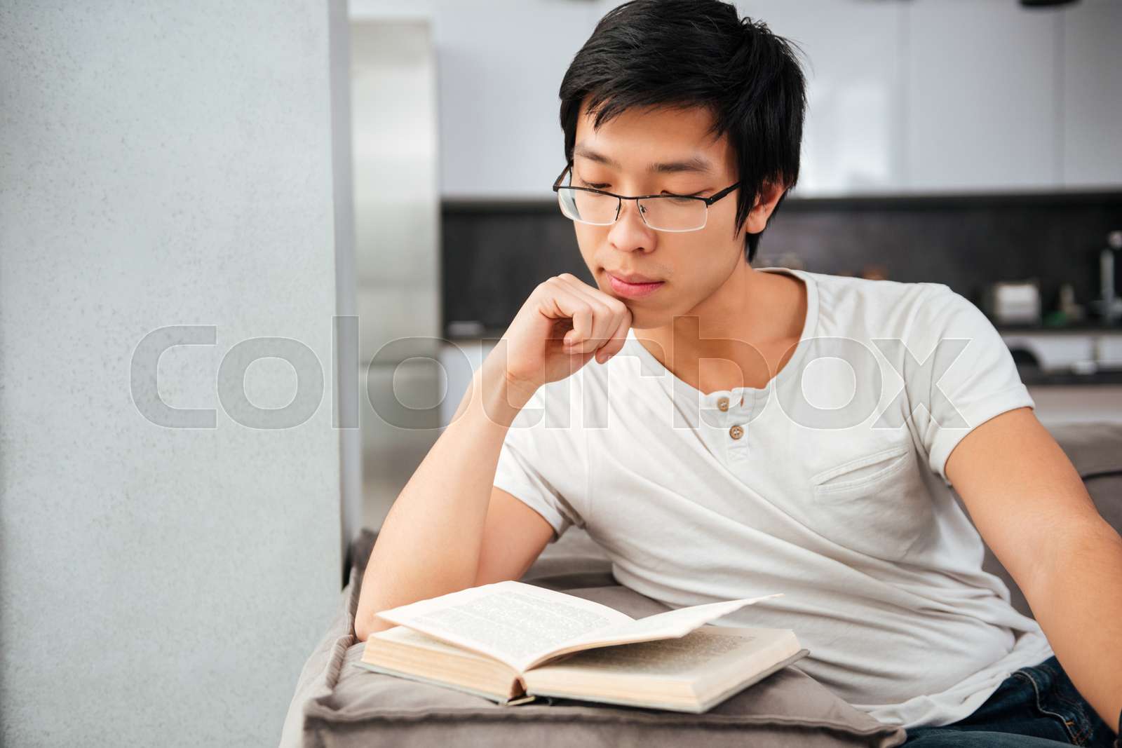 Asian man reading book | Stock image | Colourbox