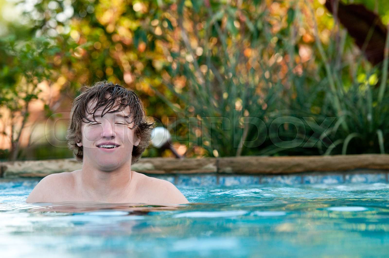 Happy teen in swimming pool with copy space. | Stock image | Colourbox