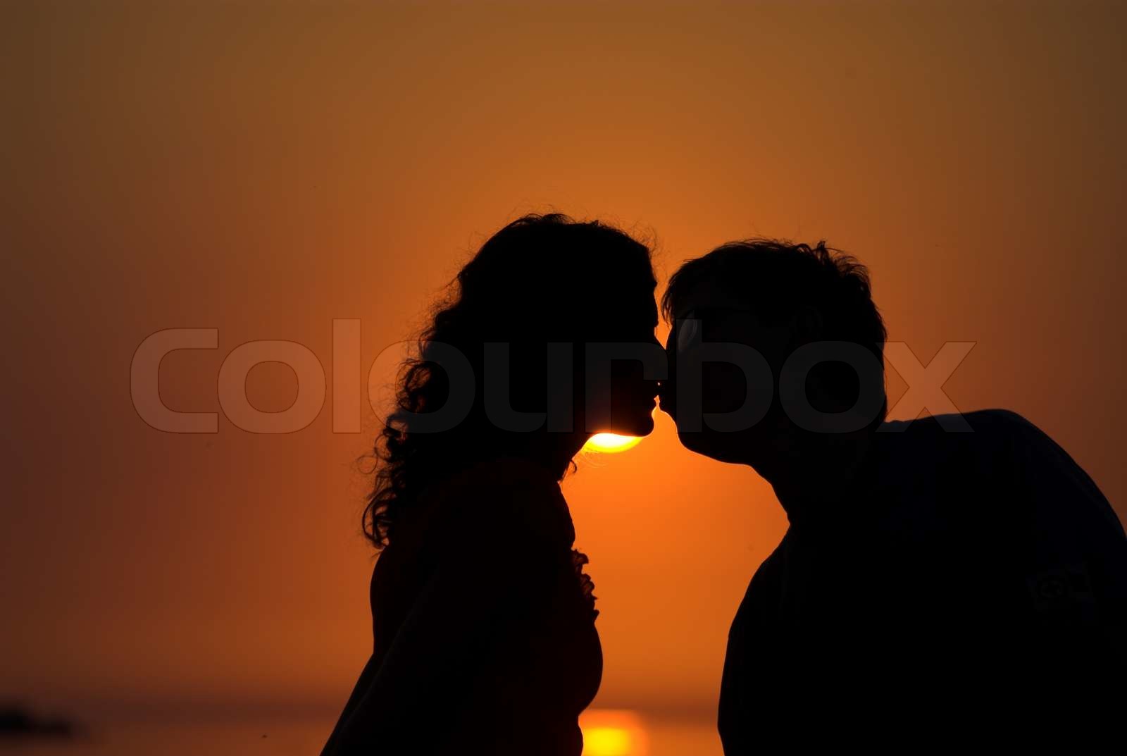 Unge par kysser på stranden | Stock foto | Colourbox