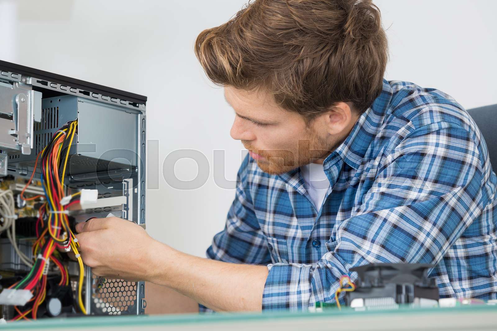 young man fixing computer | Stock image | Colourbox
