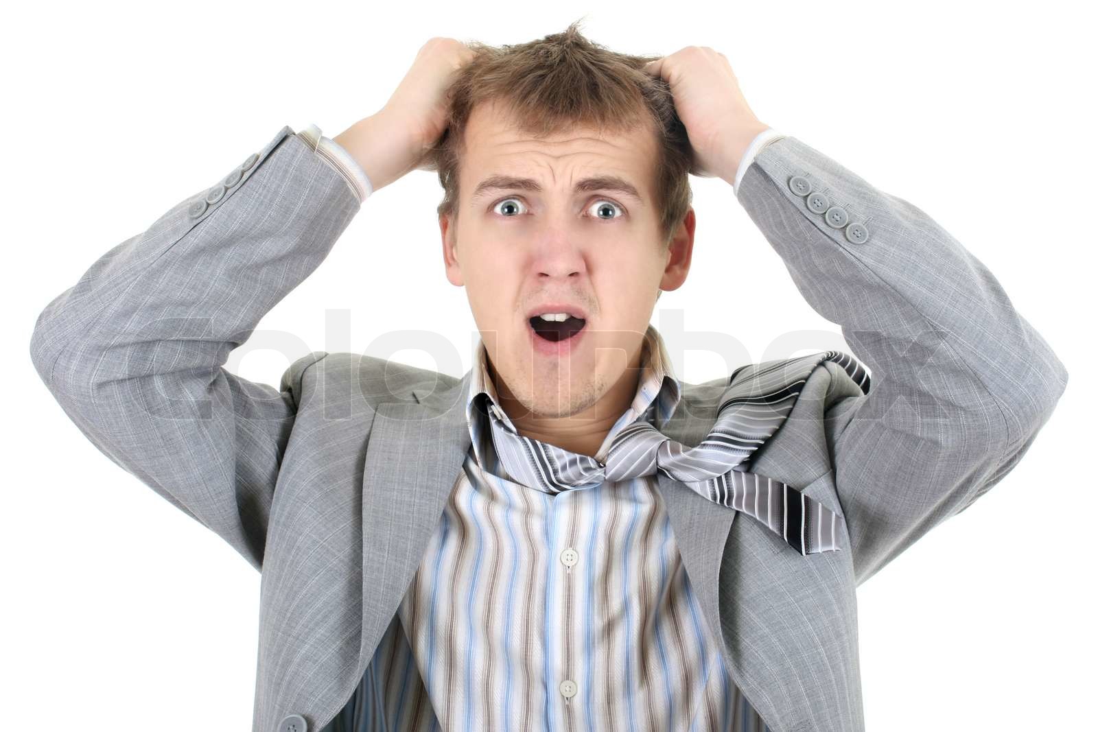 Erstaunt Geschäftsmann in grauen Anzug über weißem | Stock Bild | Colourbox