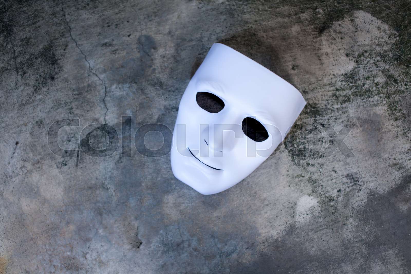 White mask on dark grunge texture | Stock image | Colourbox