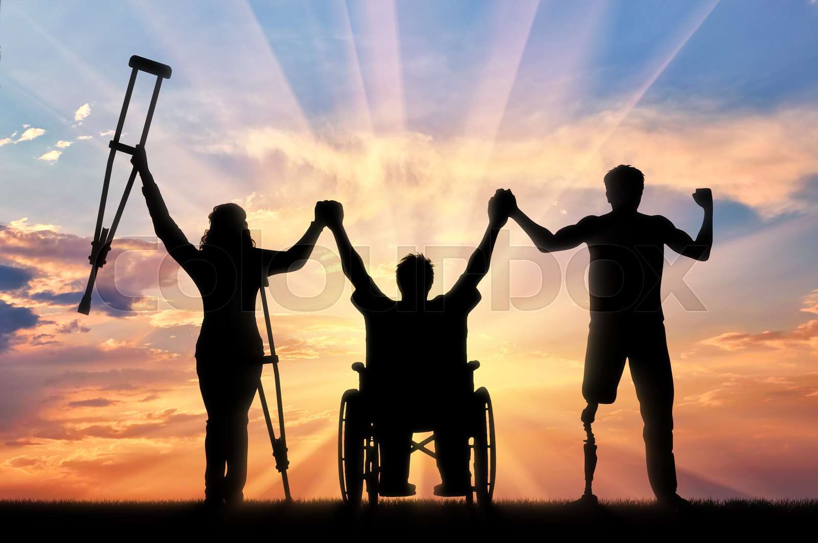 Disabled people holding hands on sunset background | Stock image ...
