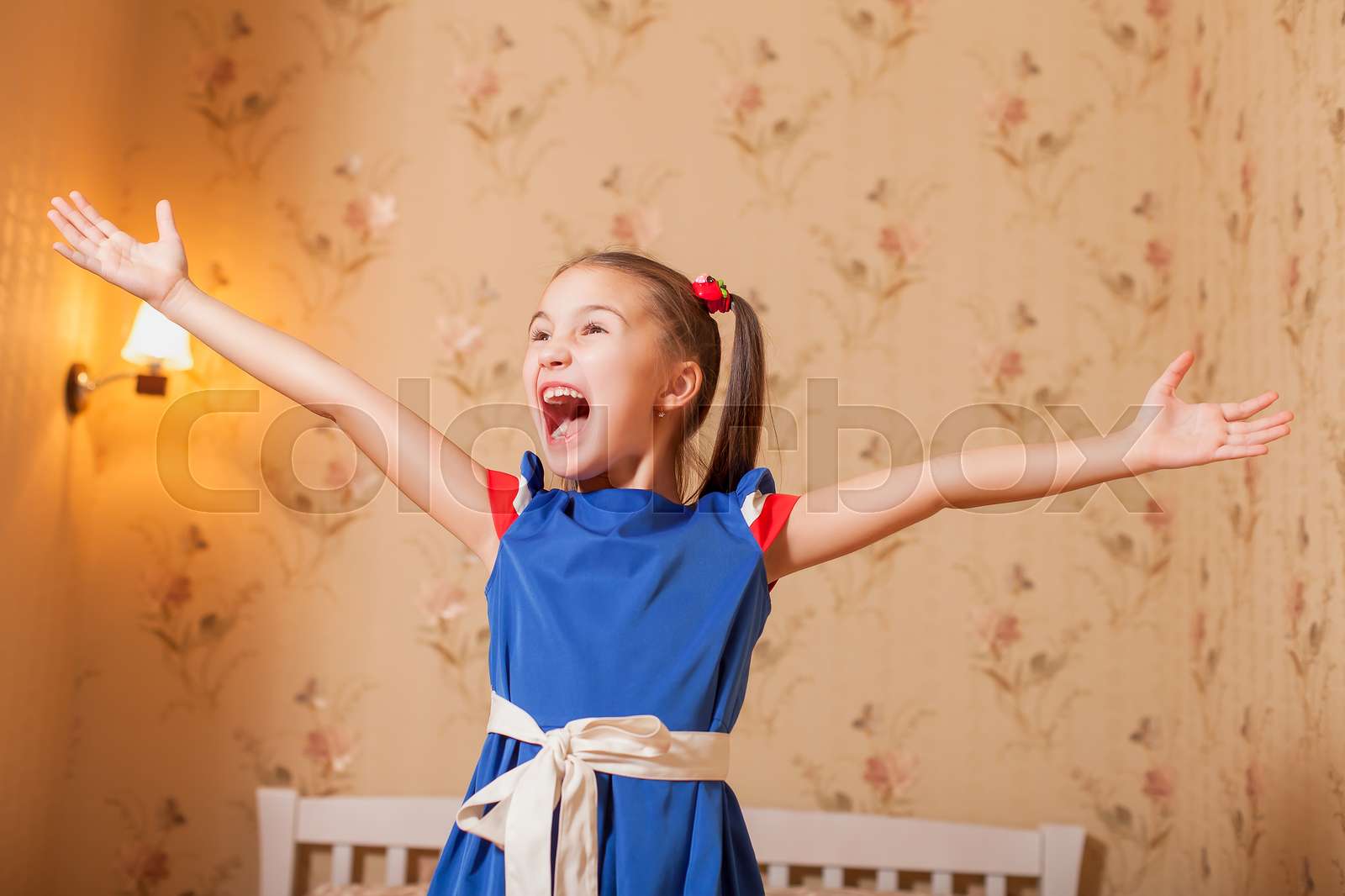 Happy little girl hands up | Stock image | Colourbox
