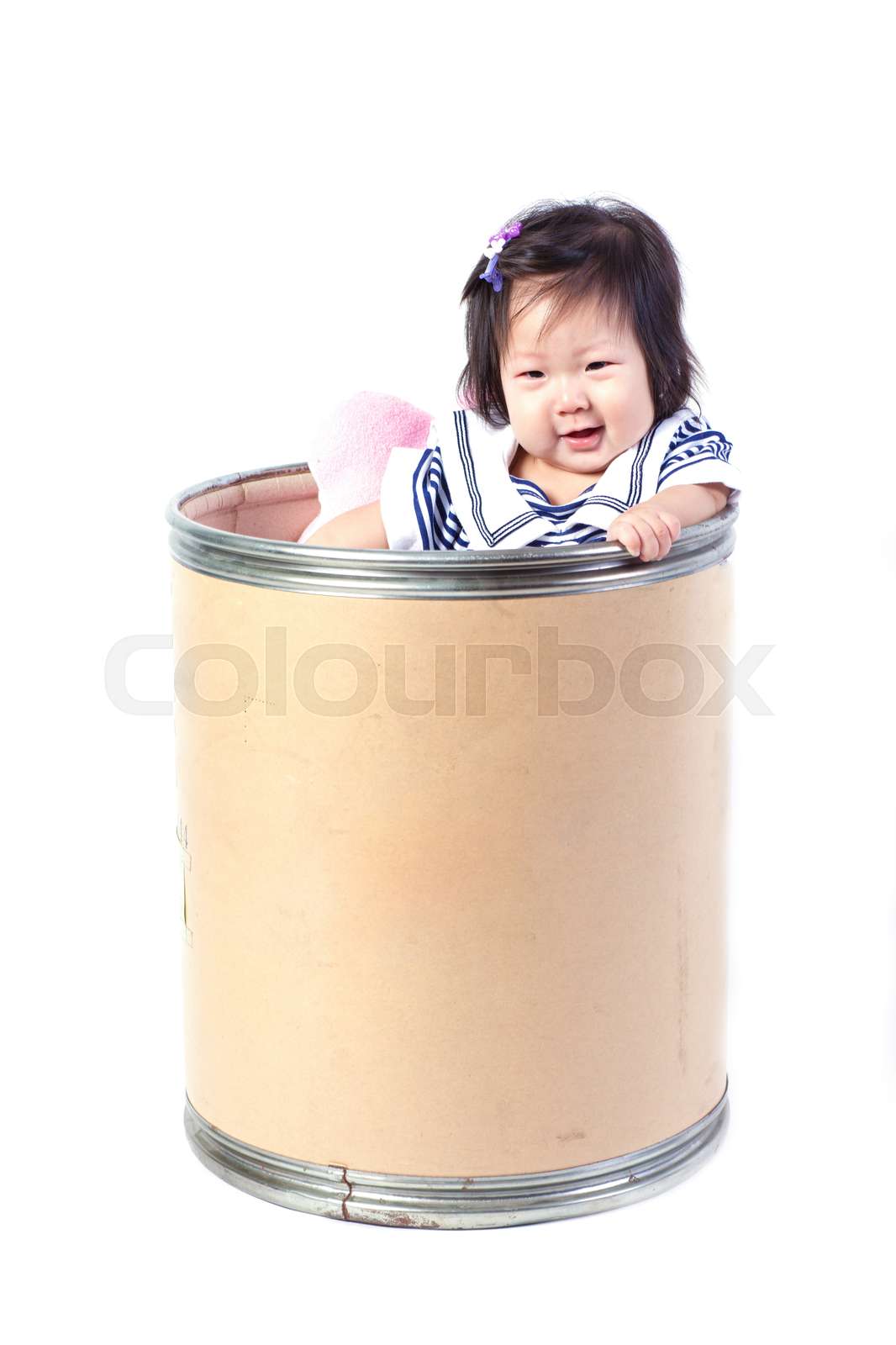 A cute girl sitting in a Chemical bucket | Stock image | Colourbox