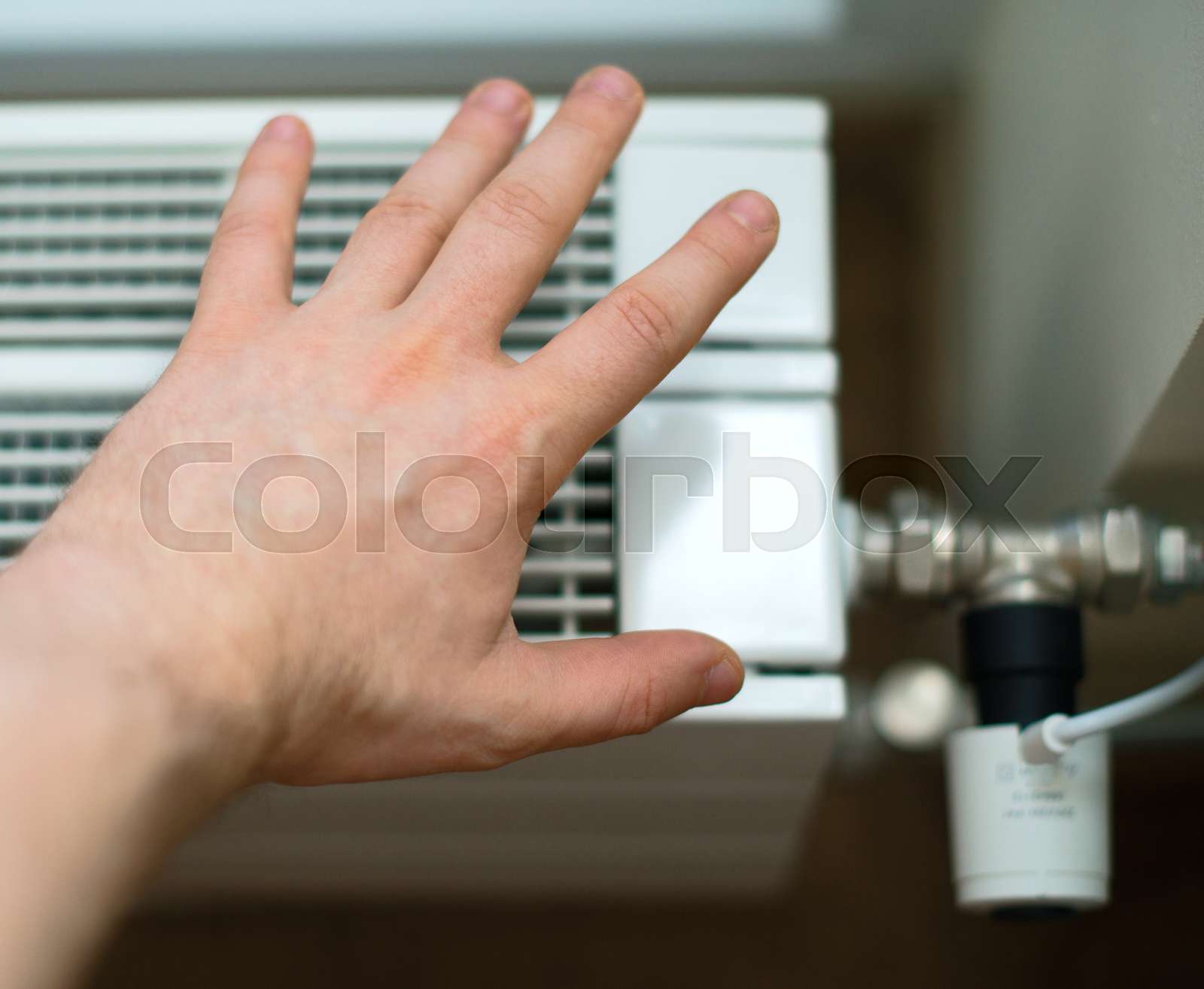 Man's hand checking temperature of heating radiator. | Stock image ...