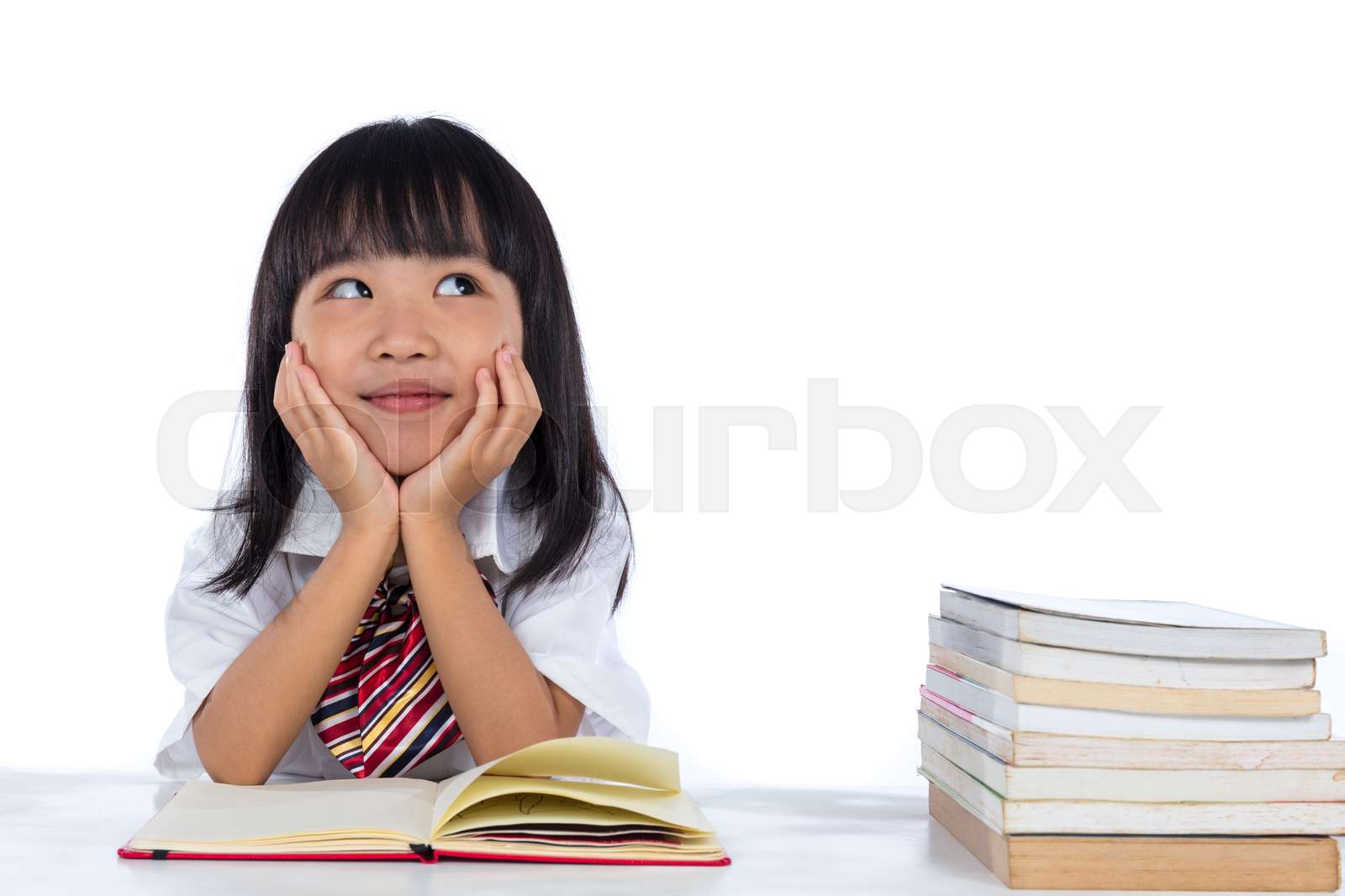 Asian Chinese little girl thinking while reading | Stock image | Colourbox