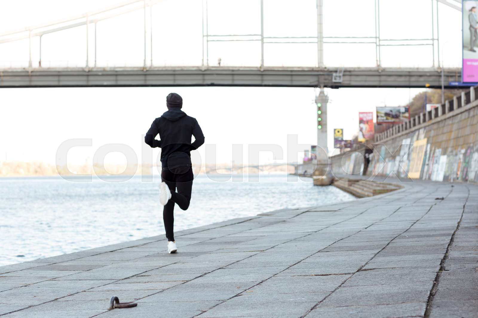 Back view of man athlete running outdoors | Stock image | Colourbox