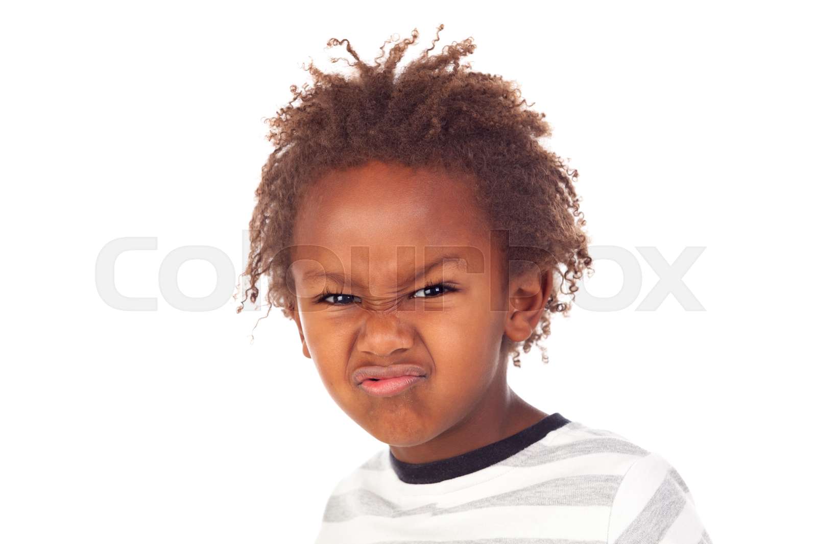African child putting mean face | Stock image | Colourbox