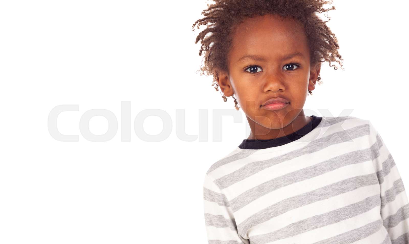 African child putting mean face | Stock image | Colourbox