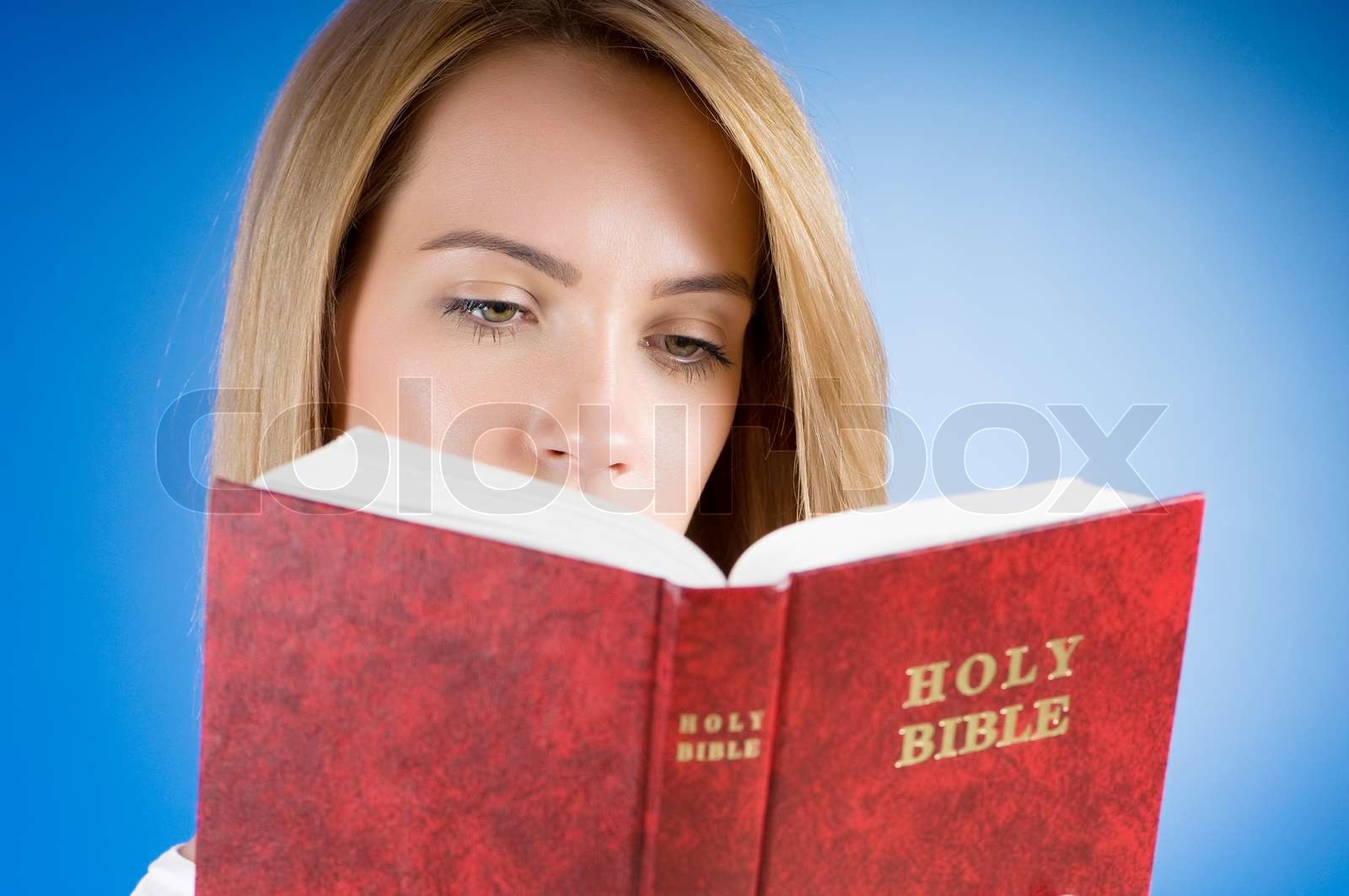Religion concept - Young girl reading holy bible | Stock image | Colourbox