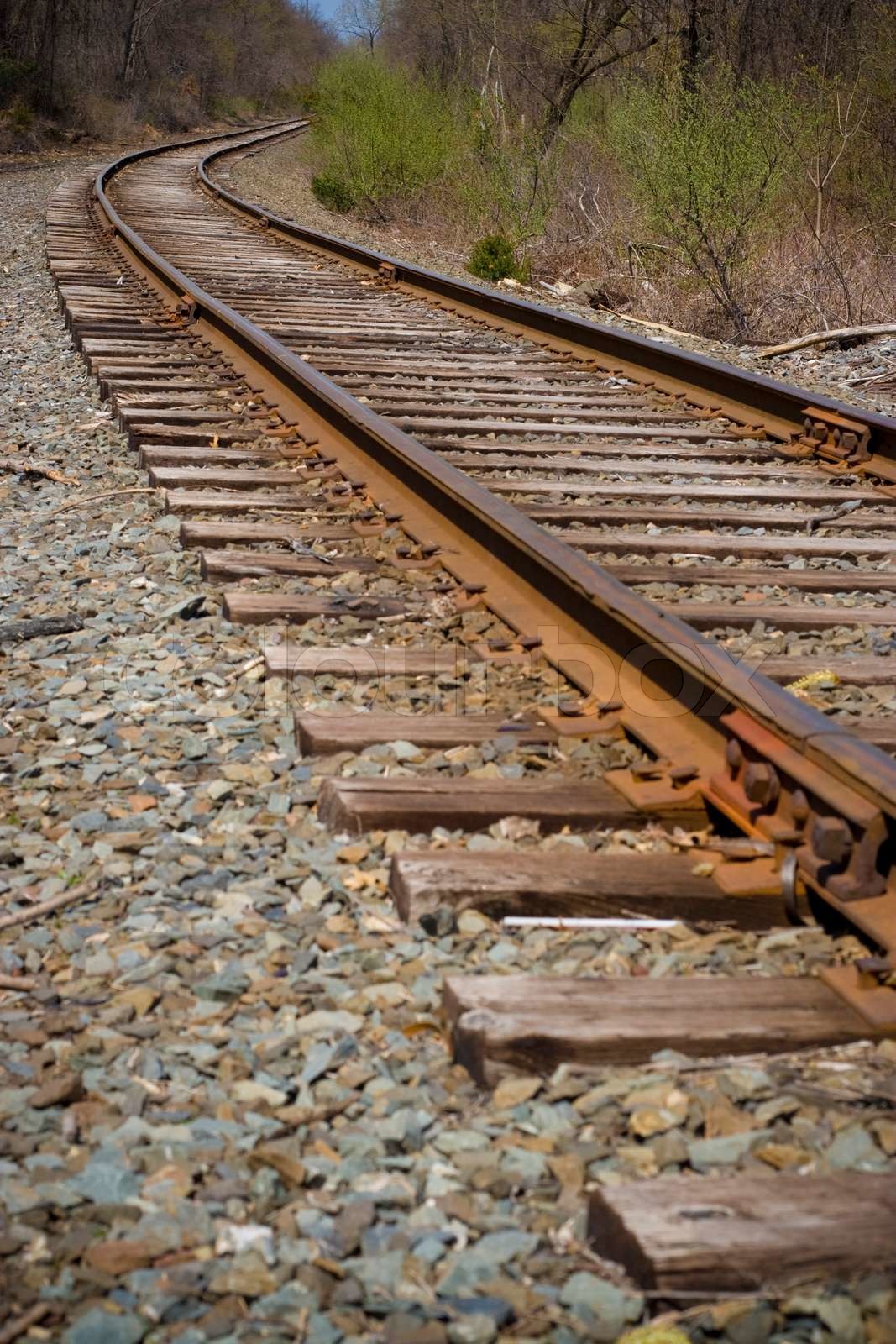 Railroad tracks curving off into the distance ahead | Stock image ...
