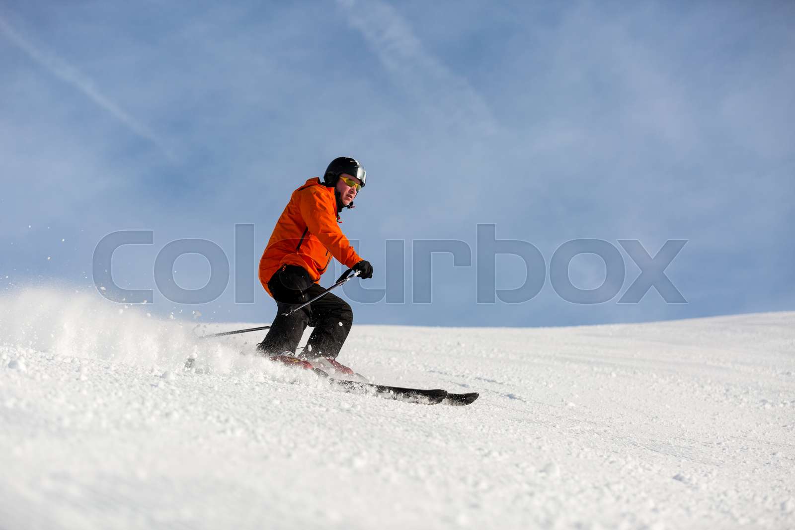 Male skier skiing on ski slope | Stock image | Colourbox