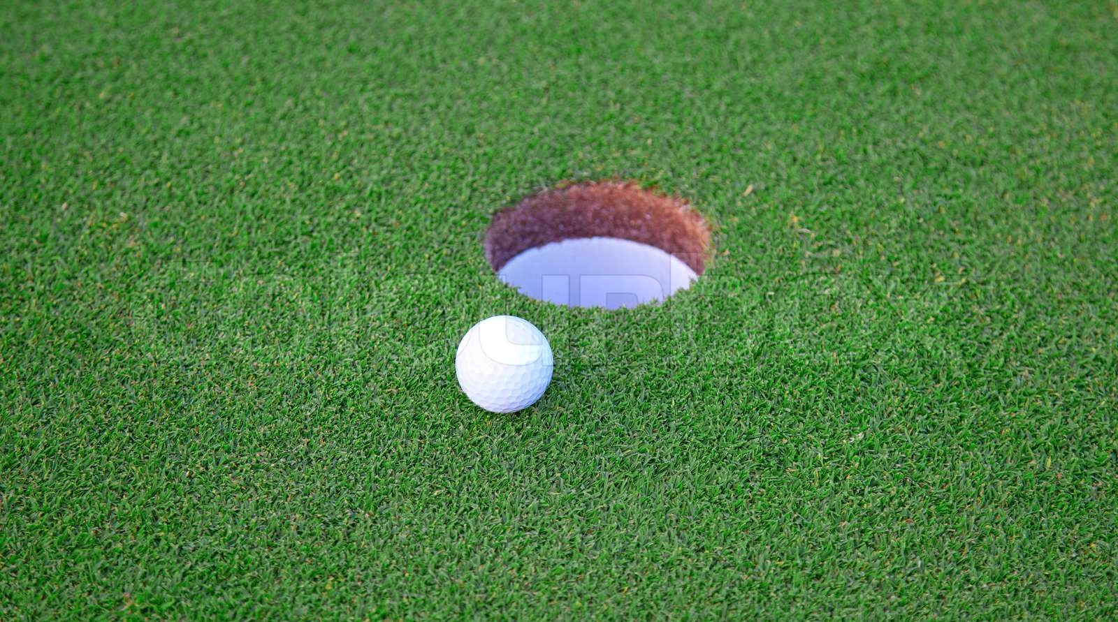 Golf ball on the green grass | Stock image | Colourbox