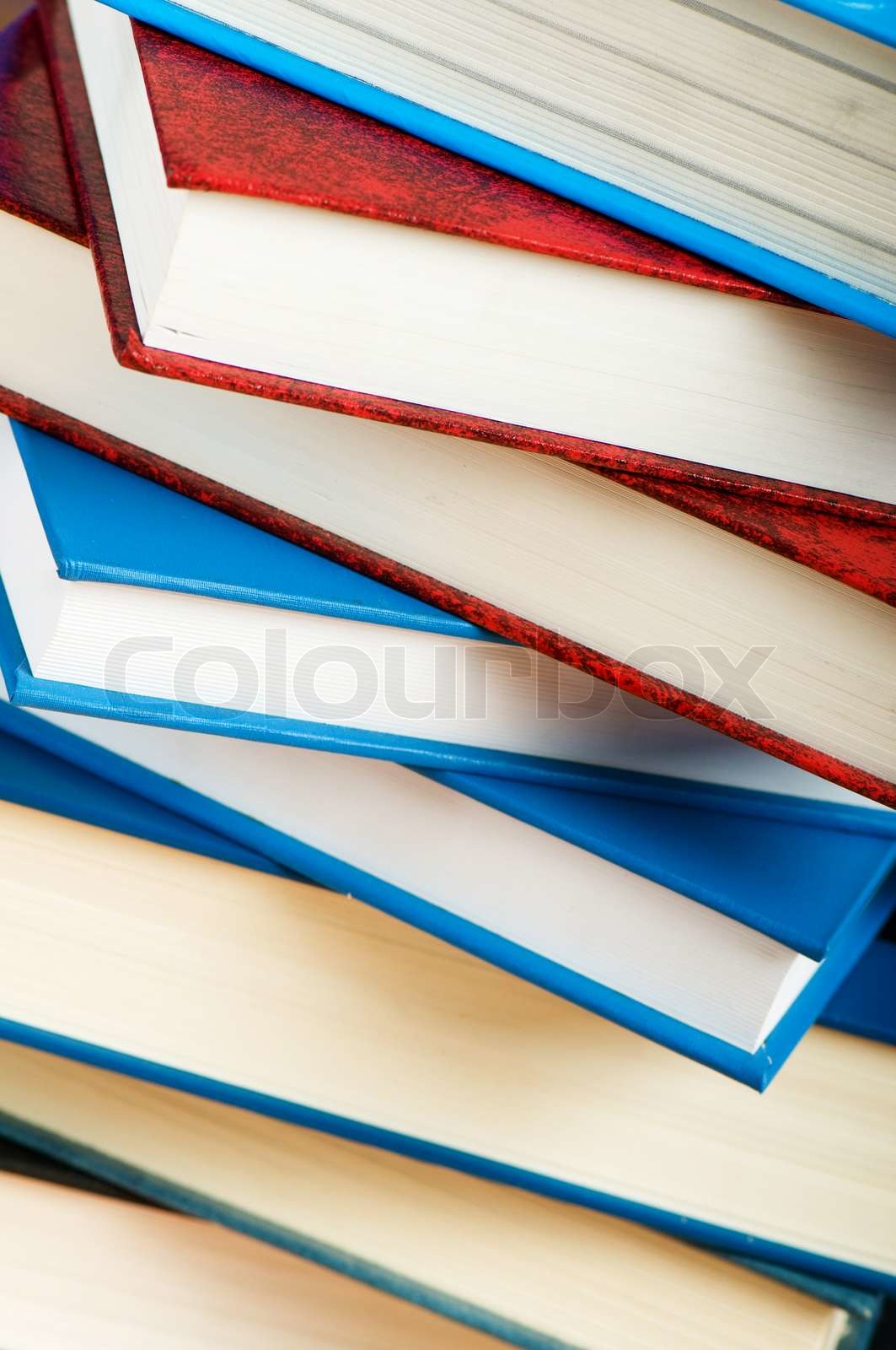 Stack of text books against gradient background | Stock image | Colourbox