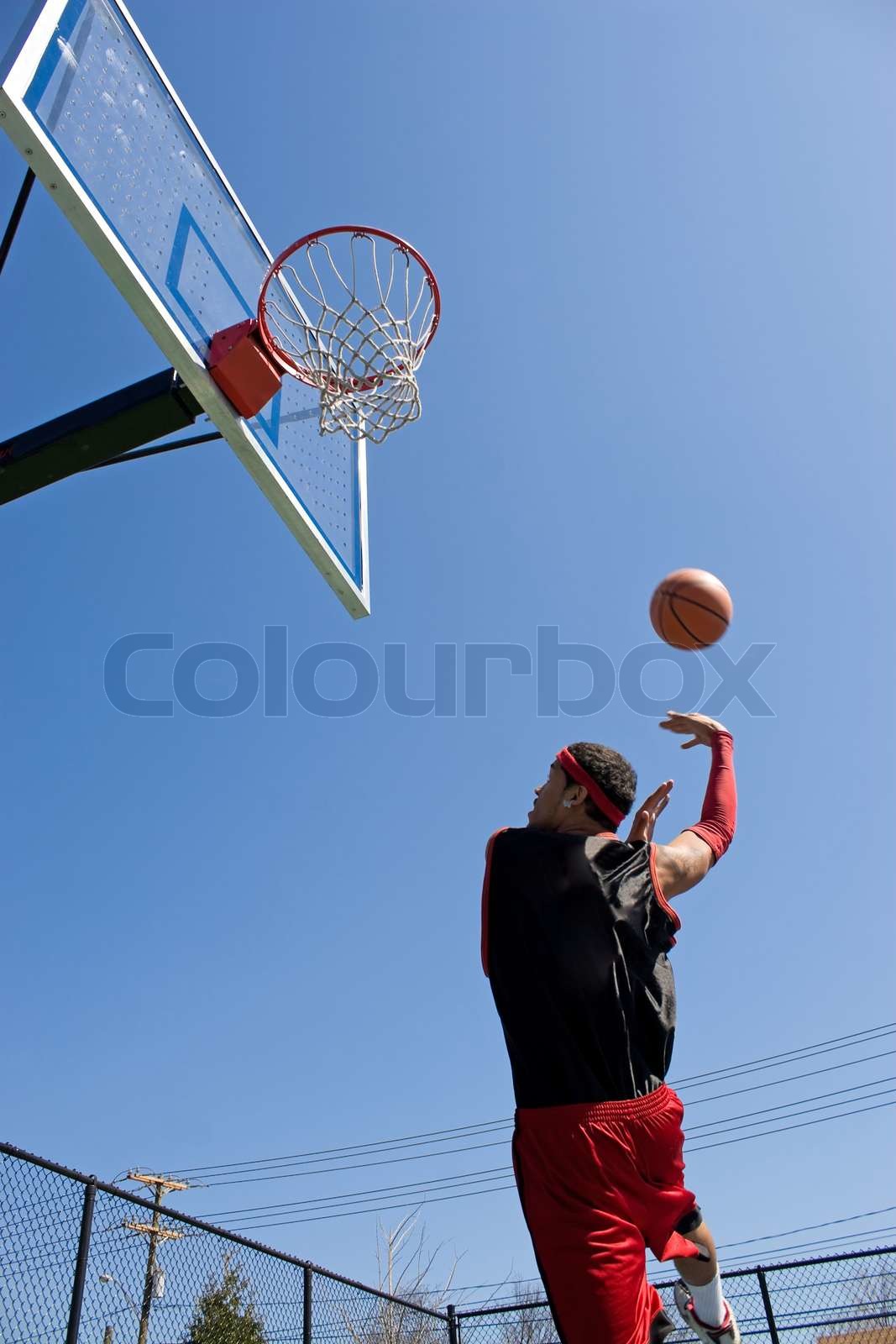 A young basketball player shooting in a hook shot or lay up | Stock ...