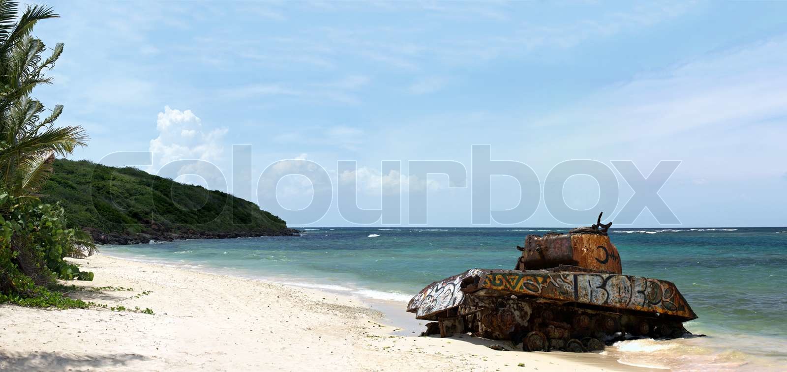 The old rusted and deserted military tank of Flamenco beach on the ...